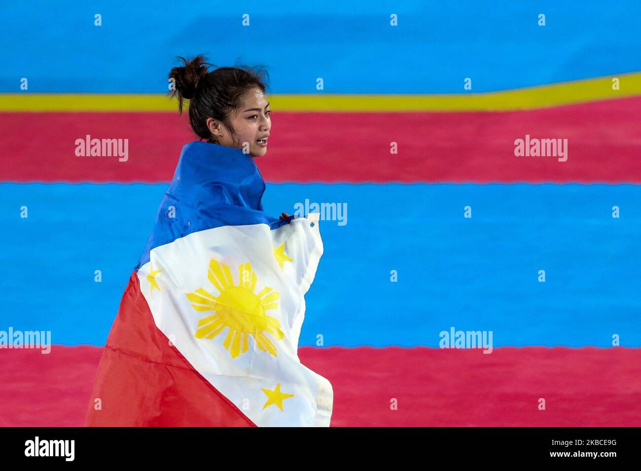 Pauline Lopez of the Philippines wears the flag in celebration after ...