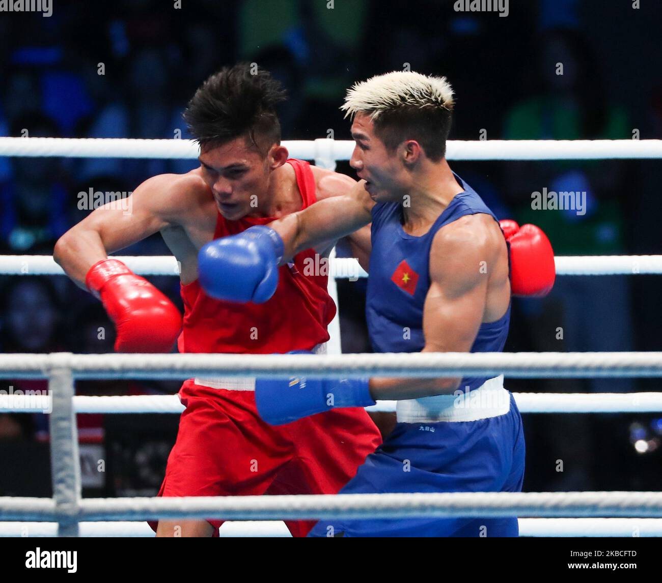 Van Hai Nguyen of Vietnam (blue) connects a right hook to James Palicte ...