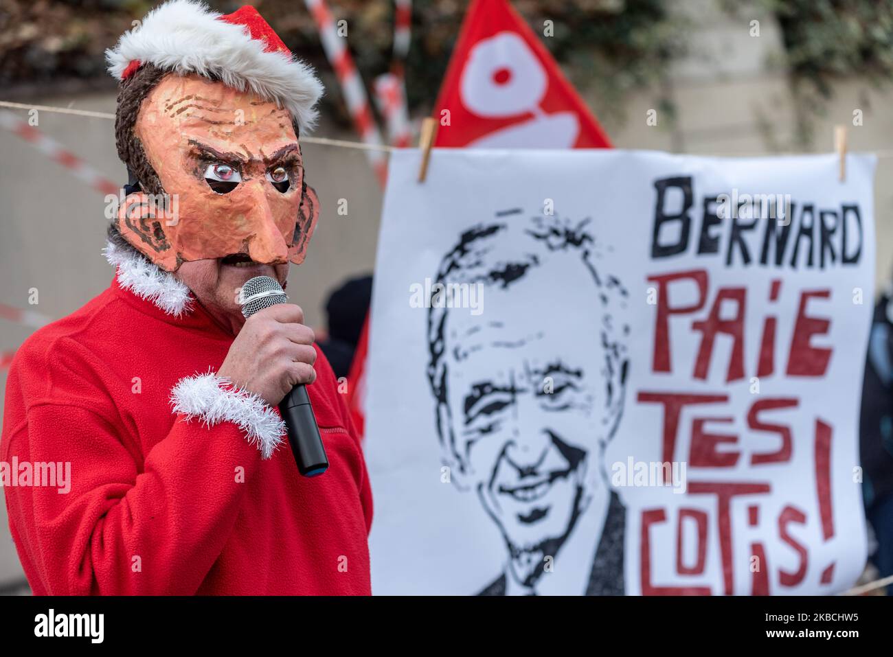 A protester disguised as Emmanuel Macron, himself disguised as Santa ...