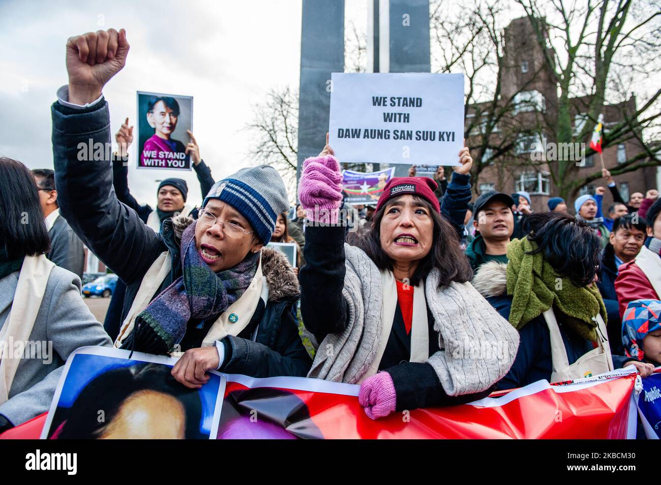 People are holding placards and shouting slogans in front of the ICJ to ...