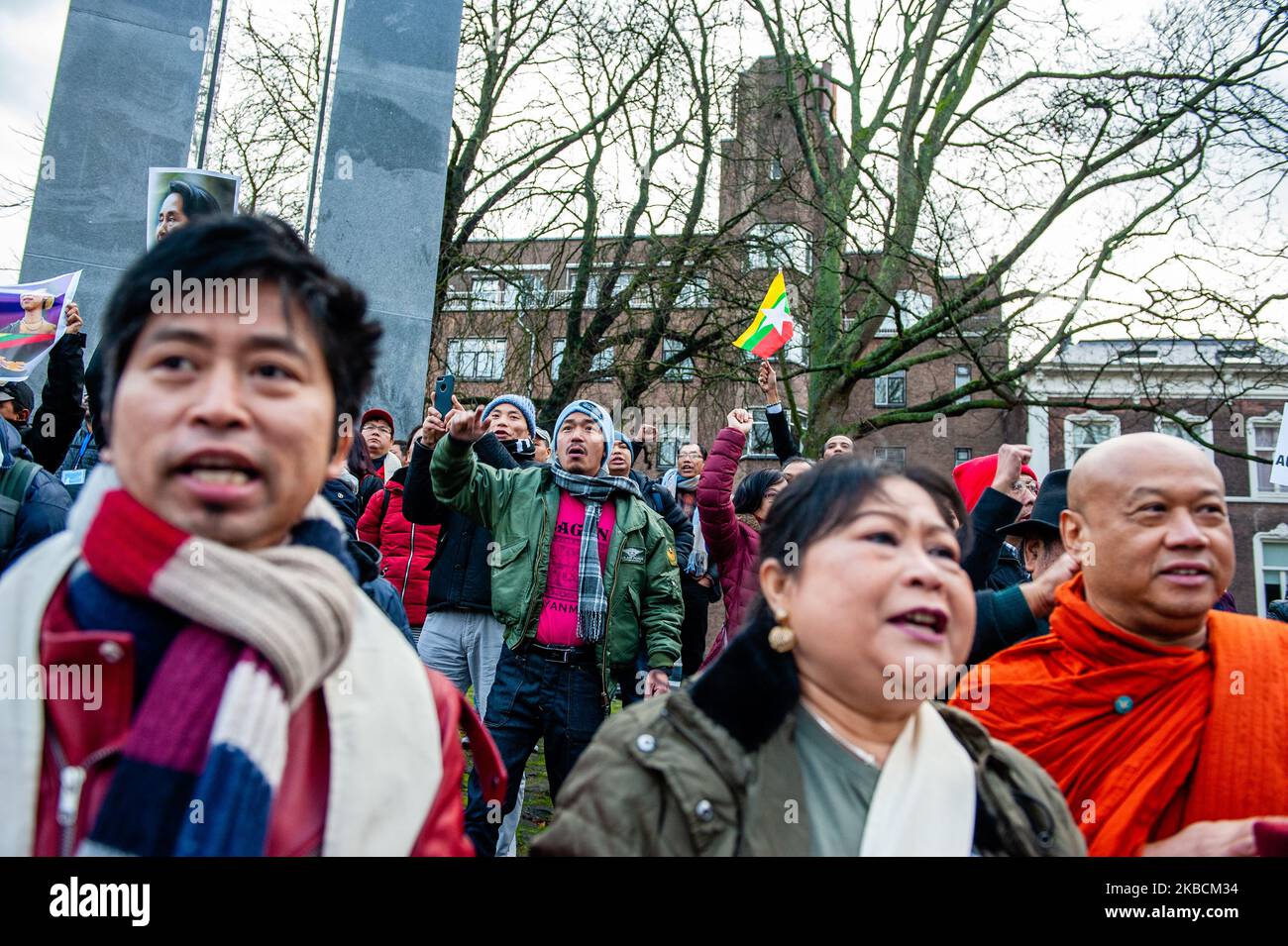 People are holding placards and shouting slogans in front of the ICJ to ...