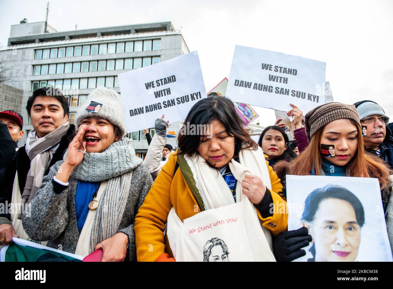 People are holding placards and shouting slogans in front of the ICJ to ...
