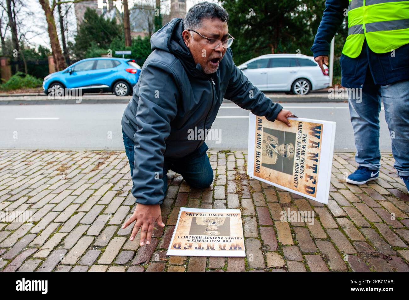 A man is spitting out over a poster of the president of Myanmar, during ...