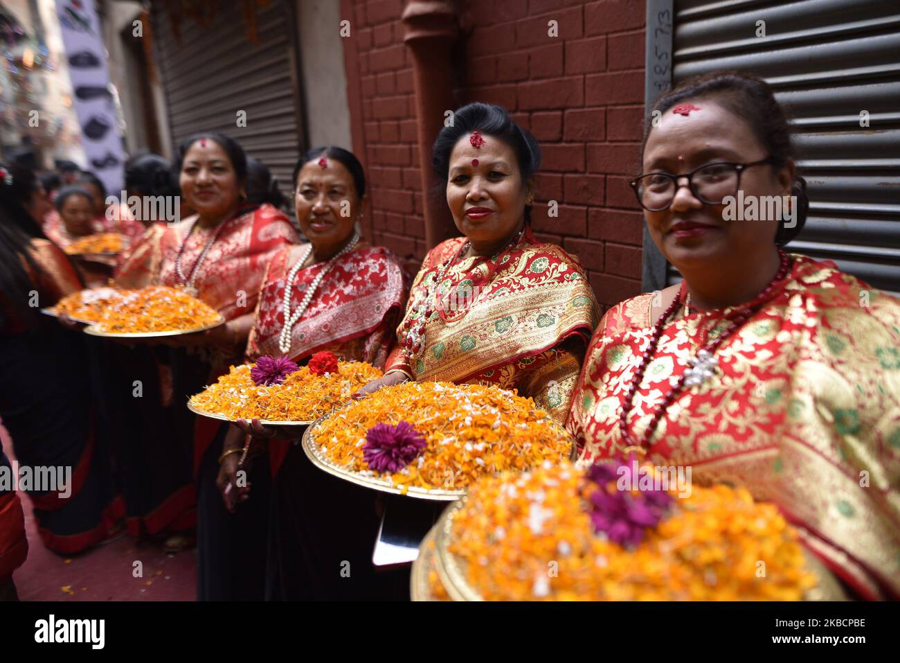 People from Newar community carrys flower to welcome people in a parade ...