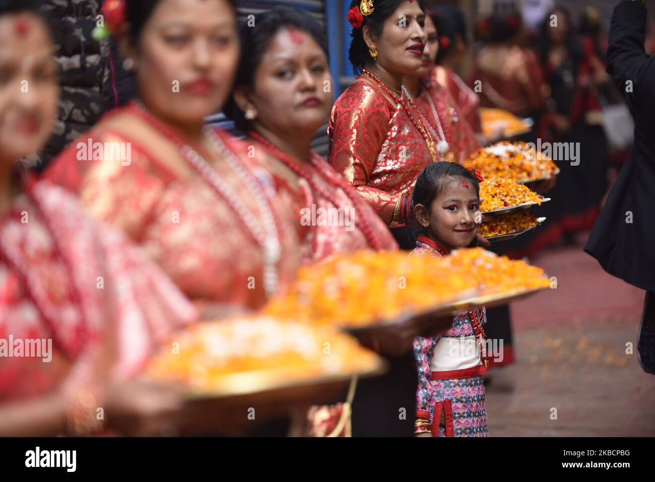 People from Newar community carrys flower to welcome people in a parade ...