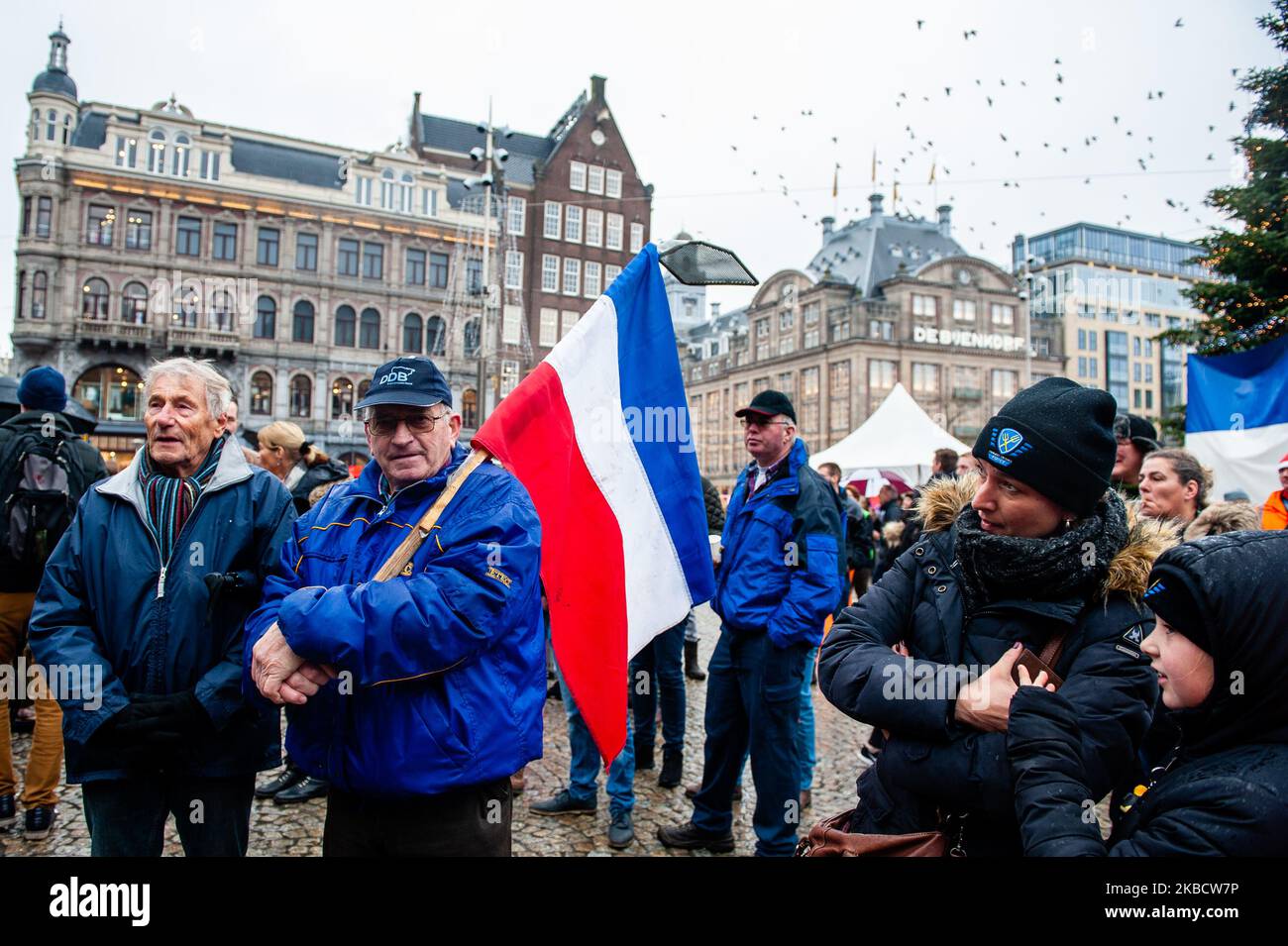 A man is holding a Dutch flag with a shovel, during the first action ...