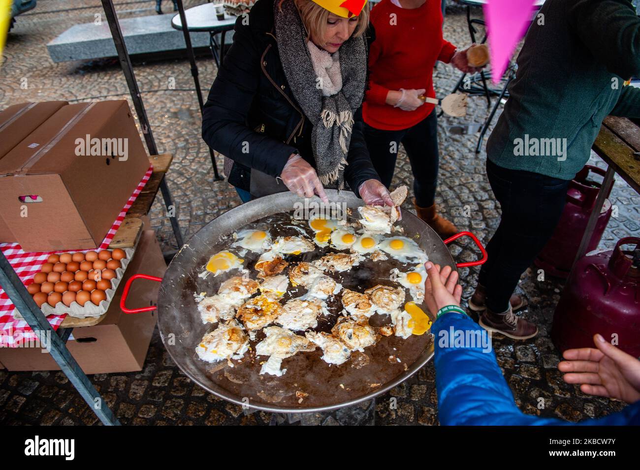 A woman is serving fried eggs, during the first action taken by farmers ...