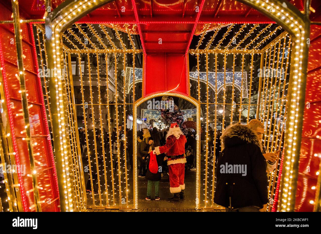 Santa Claus is seen gives presents to children at the main pedestrian ...