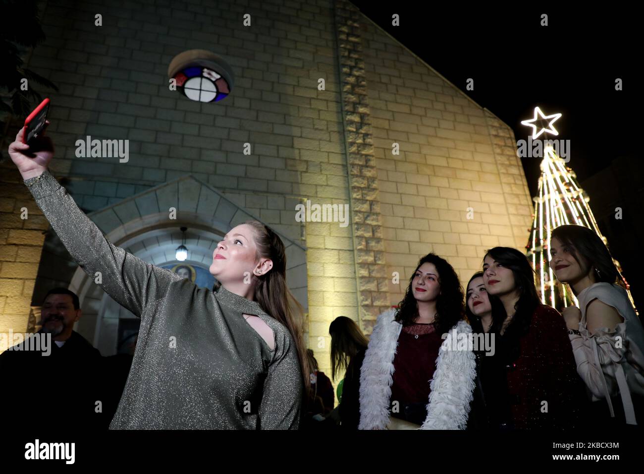 Palestinian Christians attend a Christmas tree lighting celebration on ...