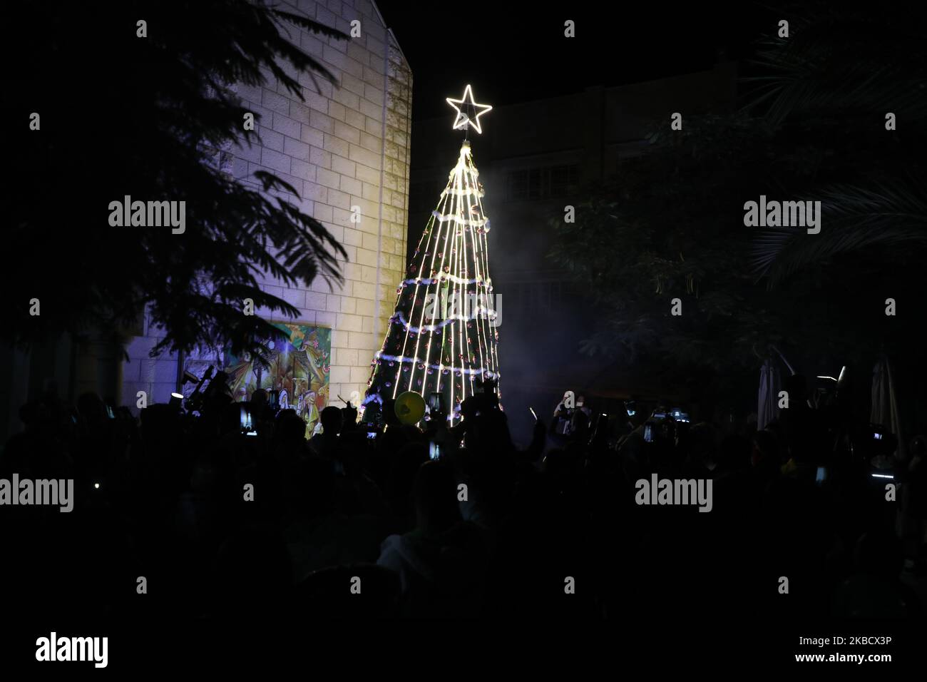 Palestinian Christians attend a Christmas tree lighting celebration on ...