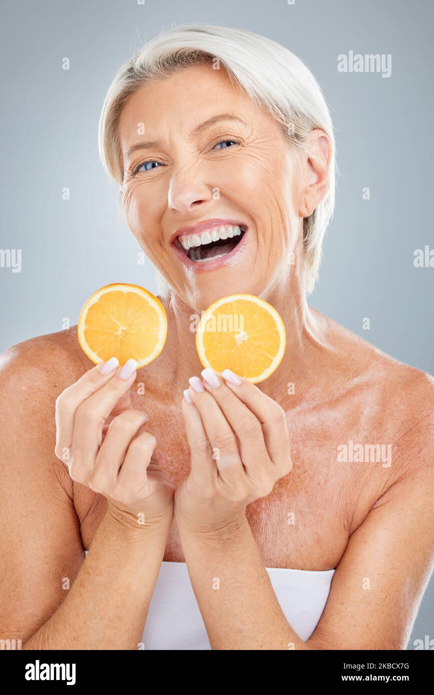 Fruit, orange and senior woman with a smile happy about skin beauty ...