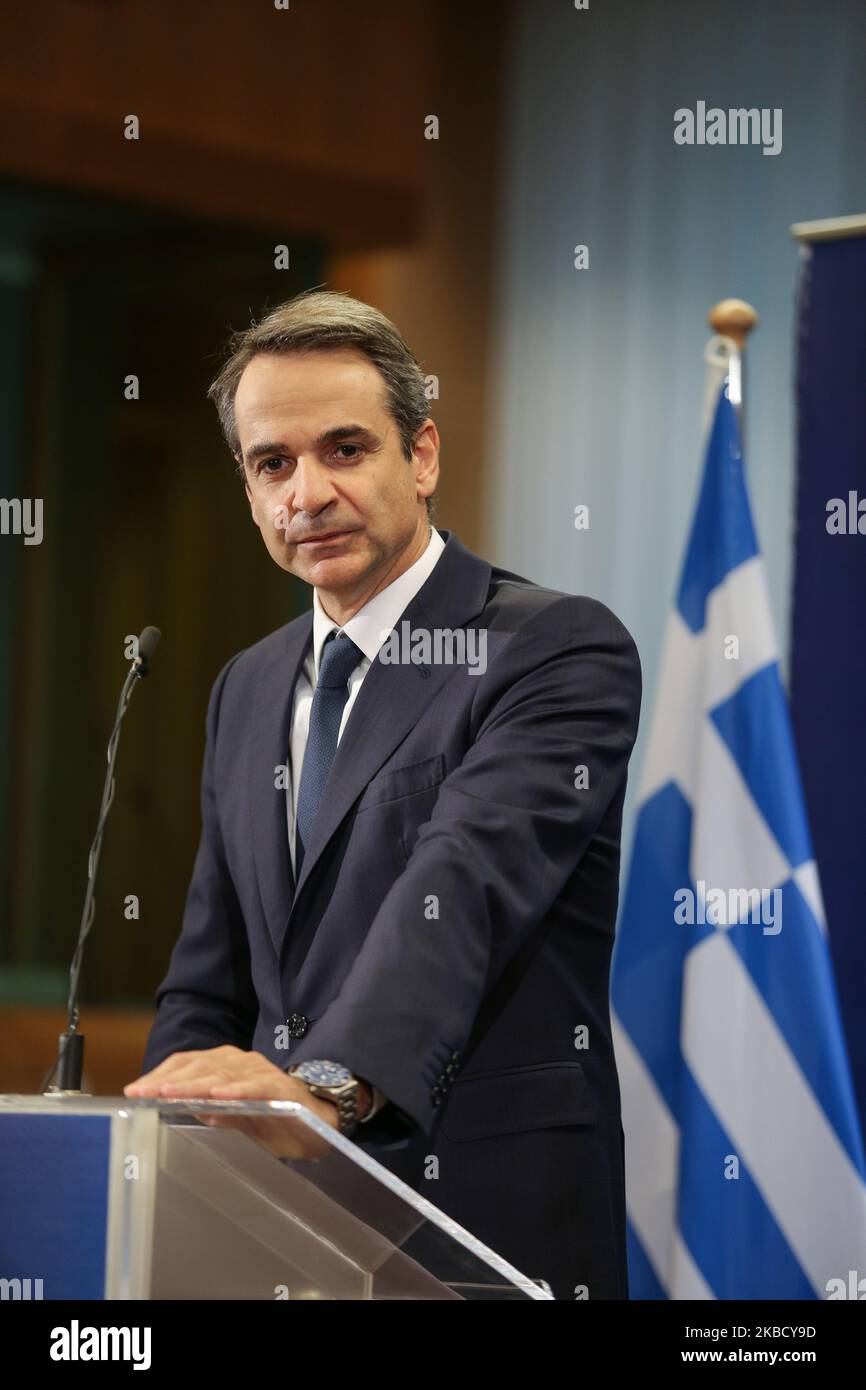 Greek Prime Minister Kyriakos Mitsotakis makes a speech as he holds a ...
