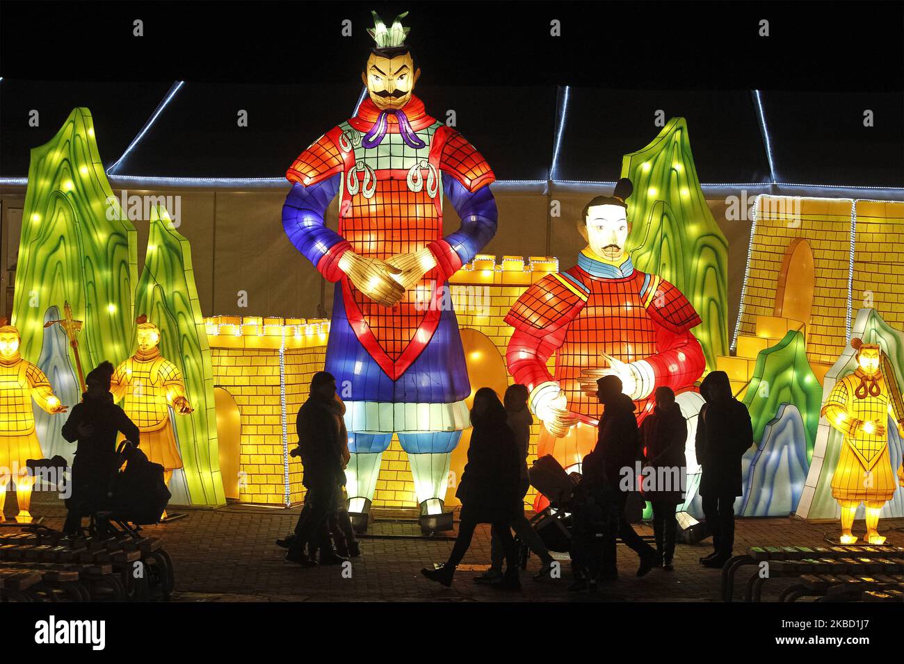 Visitors look on giant installations from lanterns, during the ...