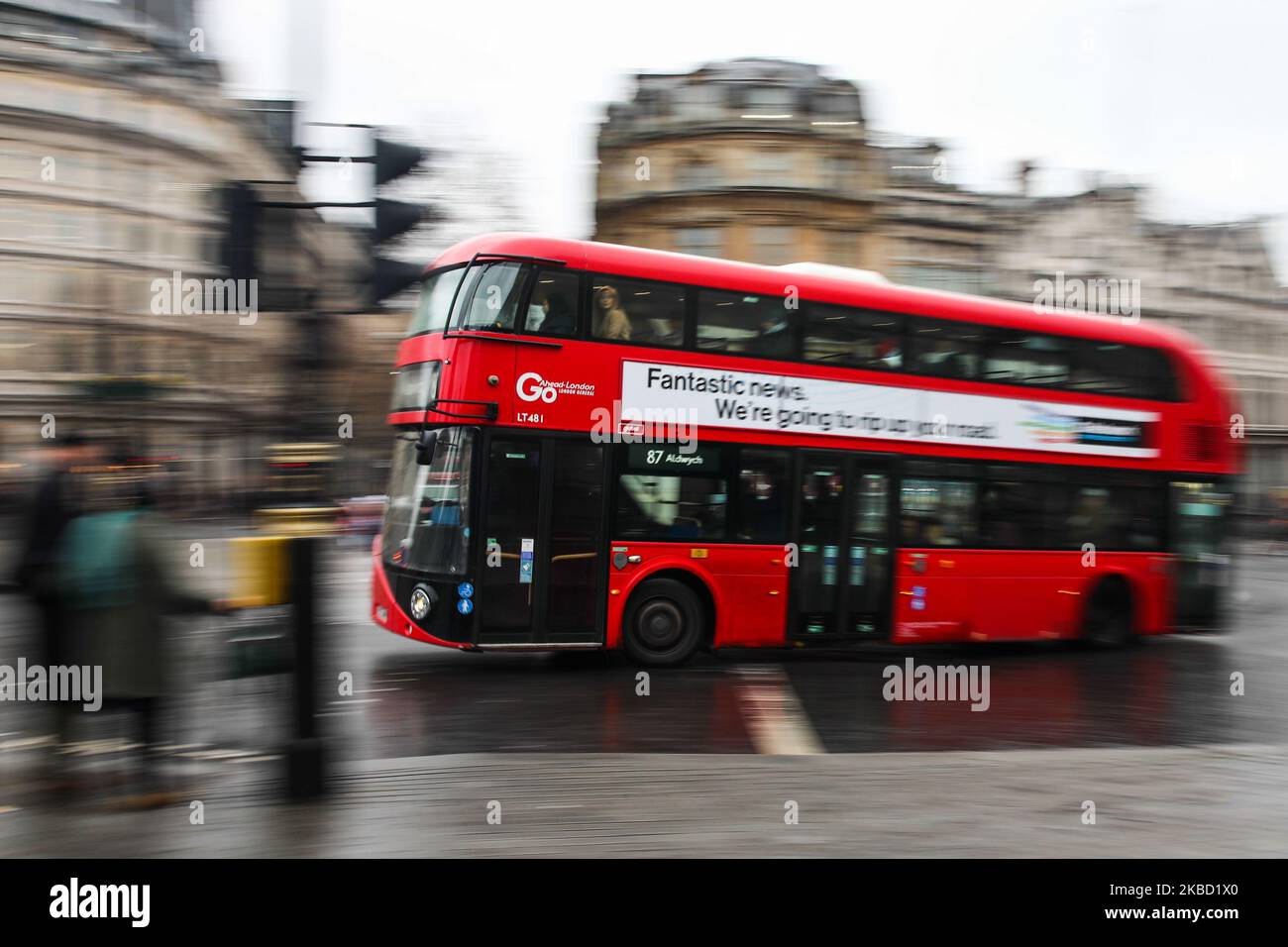 A red double-decker bus is seen at Trafalgar Square in London, Great ...