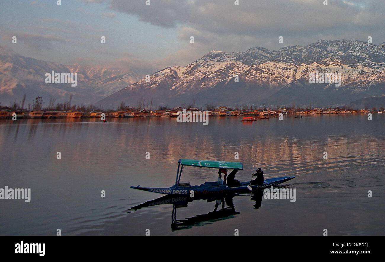 A view of famed Dal Lake with snow-capped mountains in the backdrop as ...
