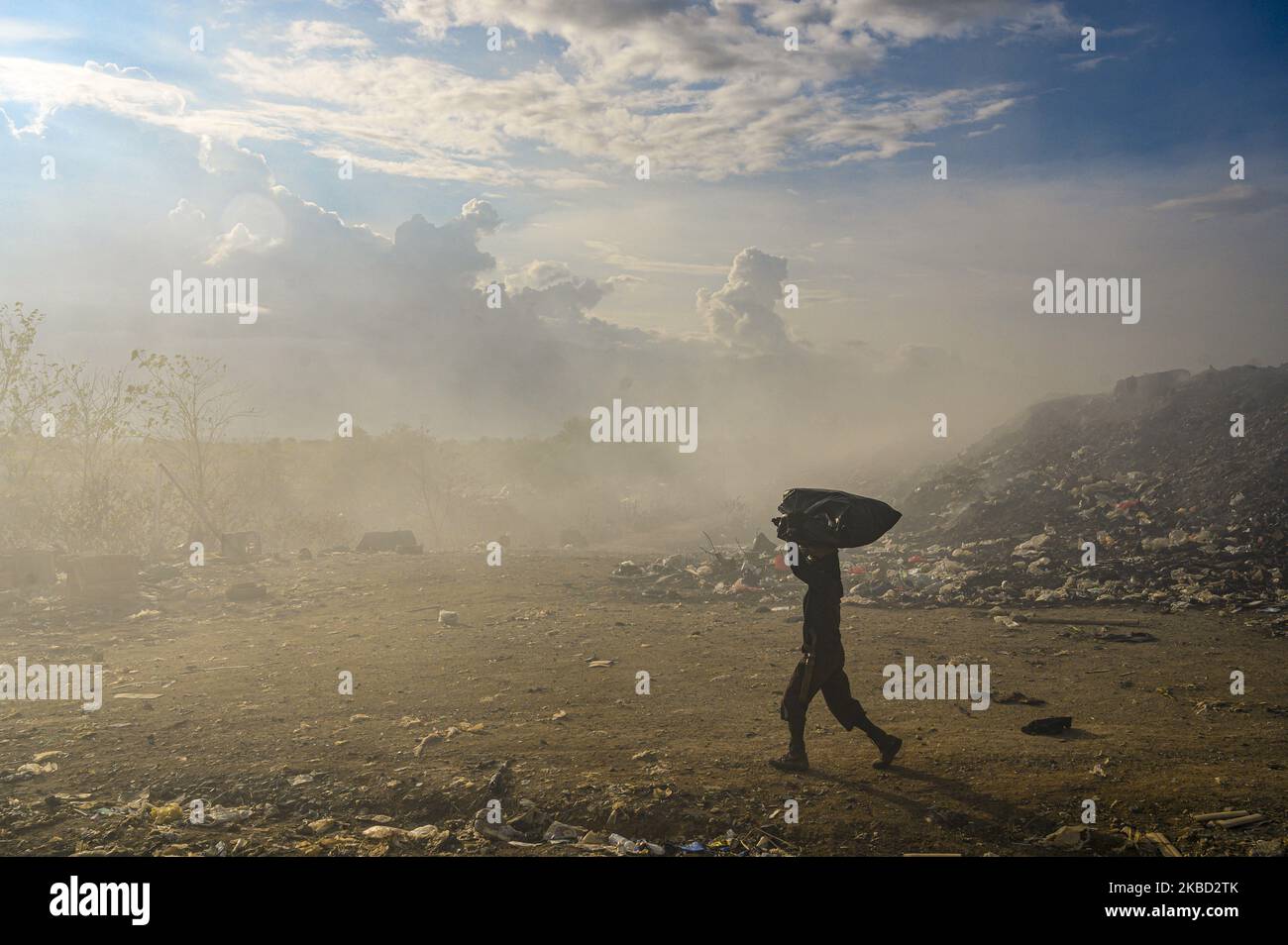 Scavengers lift their pulps through the smoke of the Kawatuna Waste ...