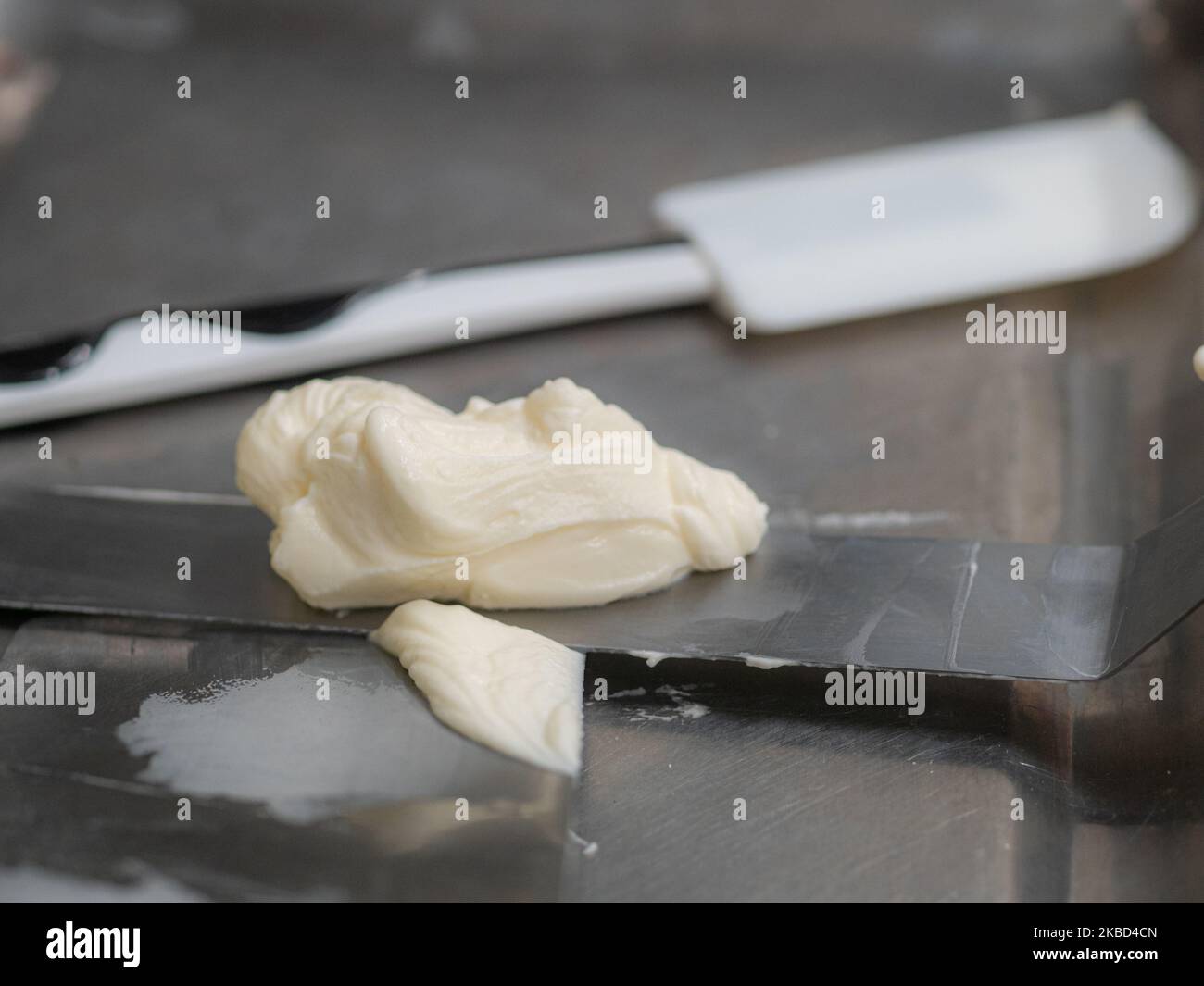pastry chef cake designer preparing blue white cheesecake in kitchen ...