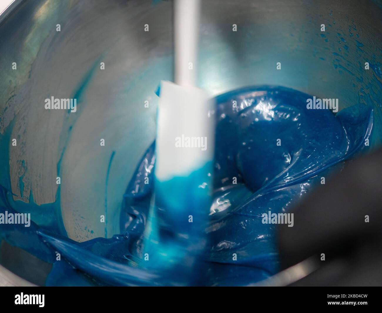 pastry chef cake designer preparing blue white cheesecake in kitchen ...