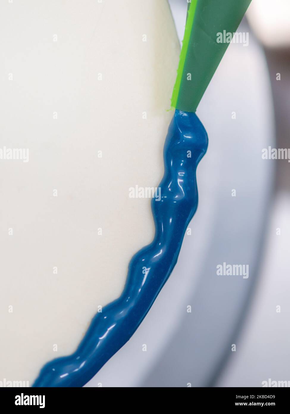 pastry chef cake designer preparing blue white cheesecake in kitchen ...