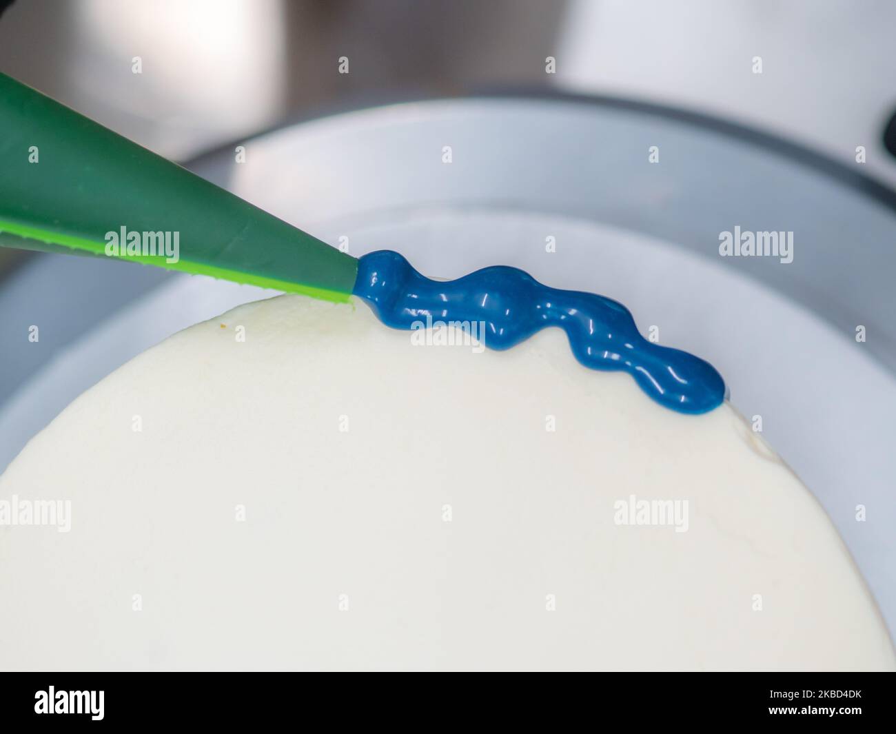 pastry chef cake designer preparing blue white cheesecake in kitchen ...