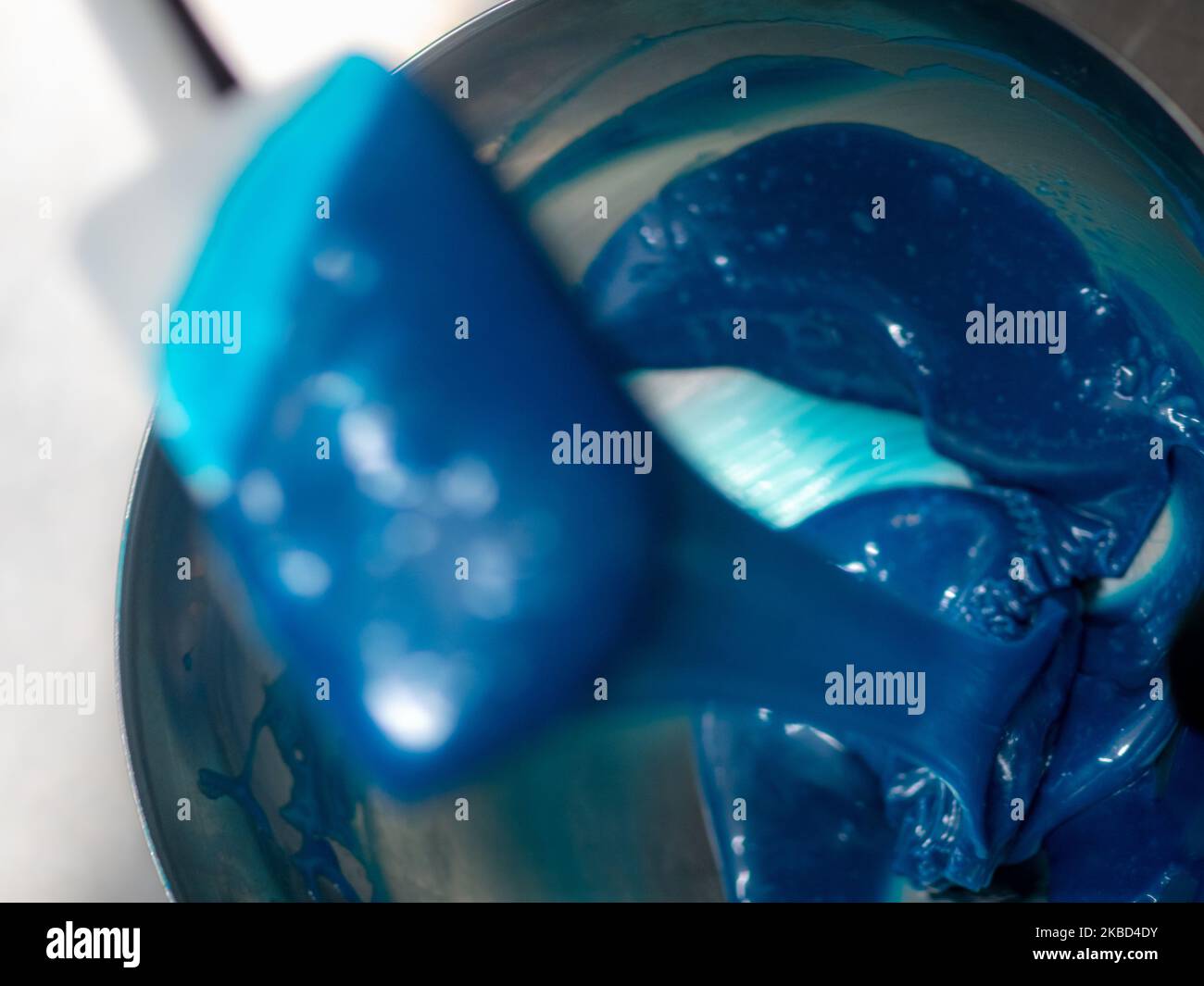 pastry chef cake designer preparing blue white cheesecake in kitchen ...