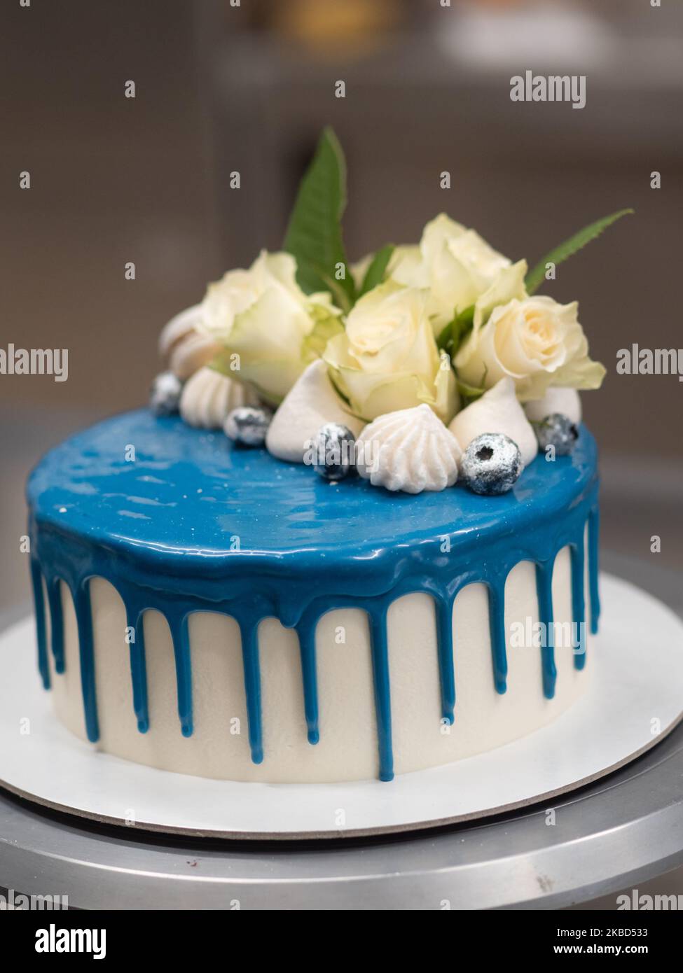 pastry chef cake designer preparing blue white cheesecake in kitchen ...