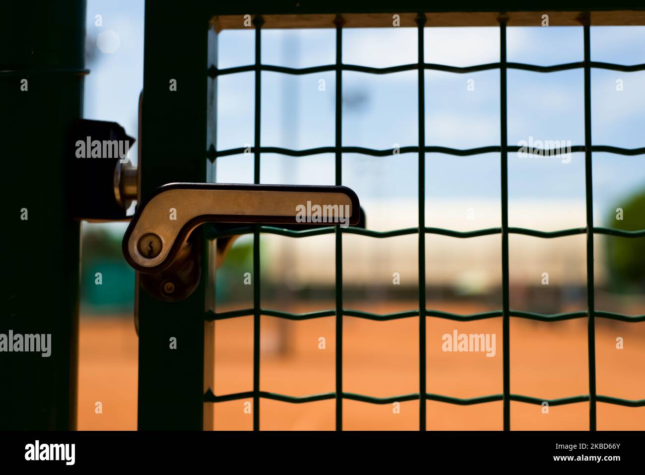 Sports ground fencing. Entrance. Entrance handle and lock. Metal mesh ...