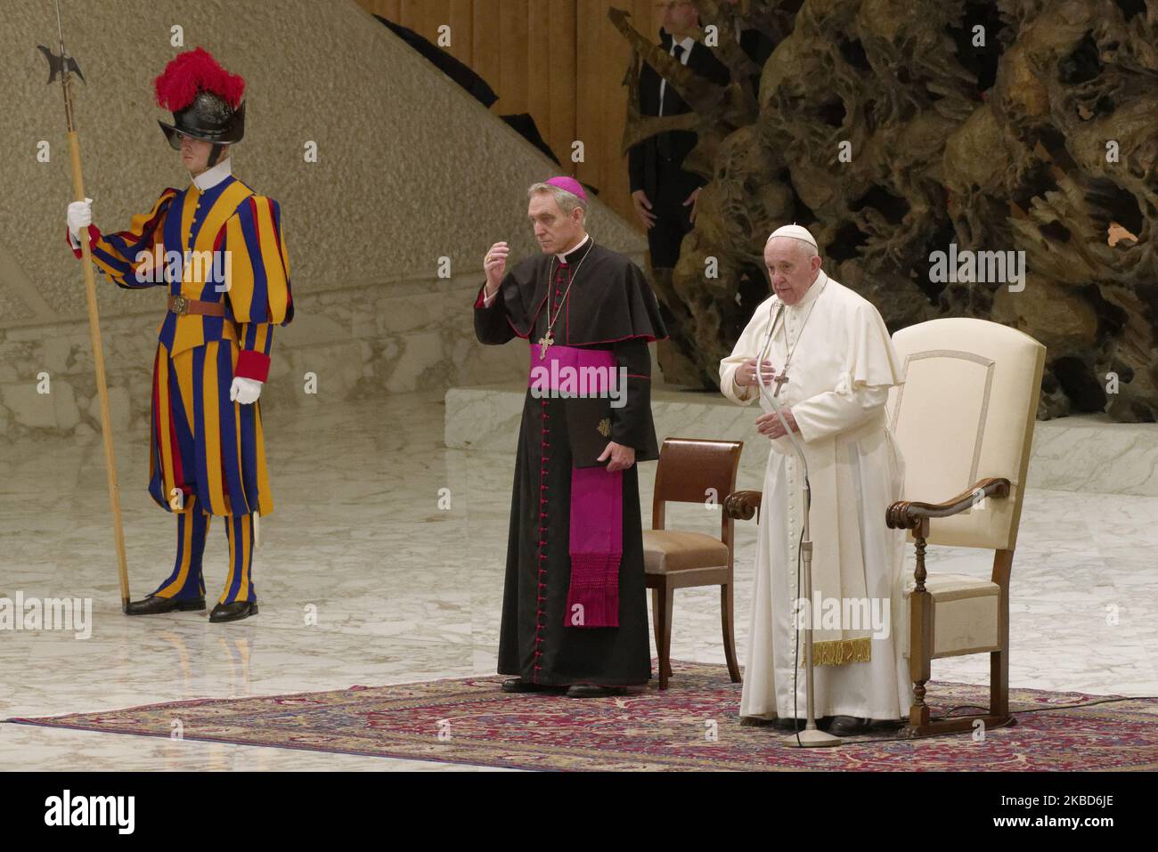 Pope Francis makes the sign of the cross as he arrives in the Paul VI ...