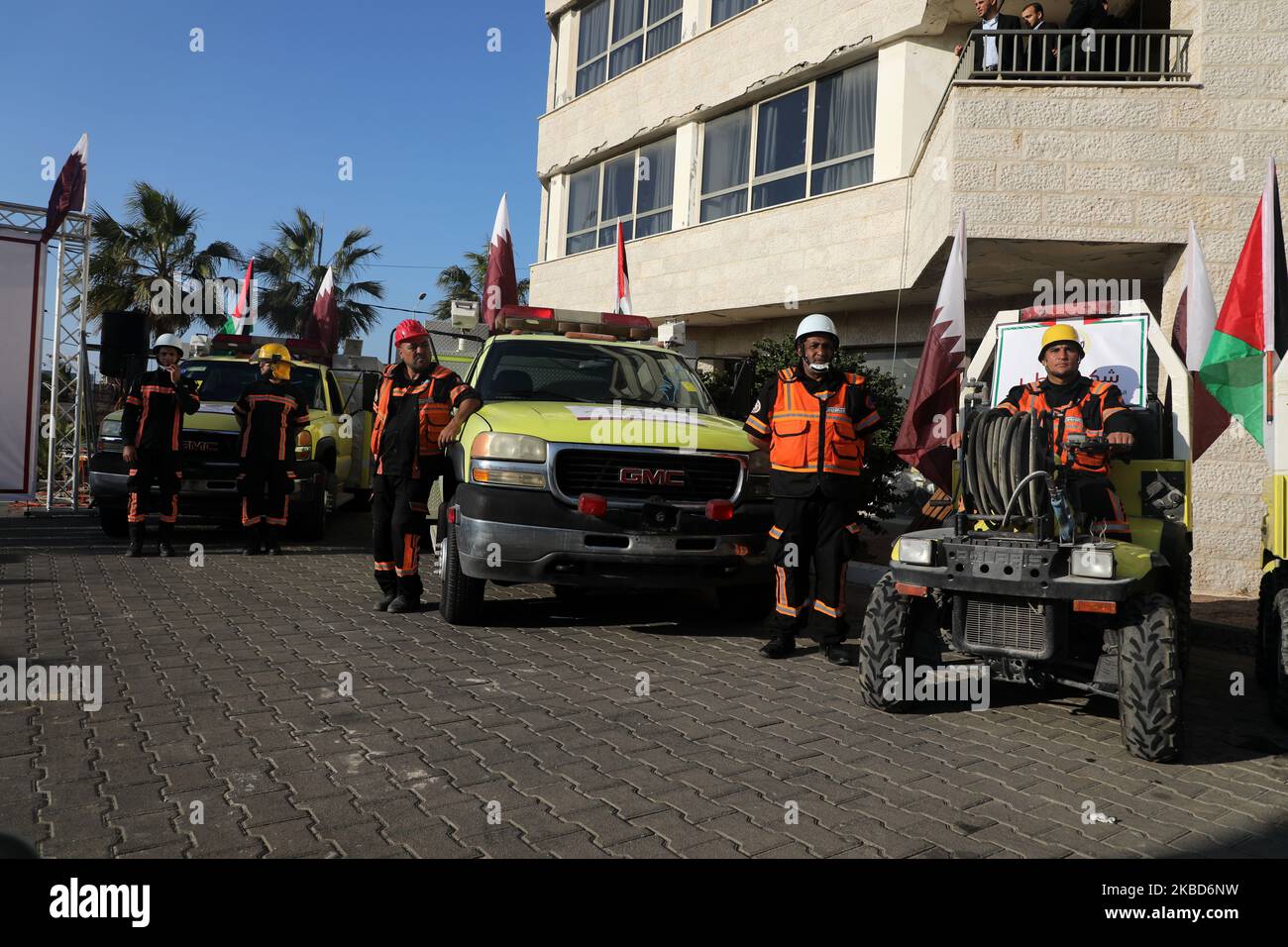 Palestinian Civil Defense Forces stand next to 24 vehicles, donated by ...