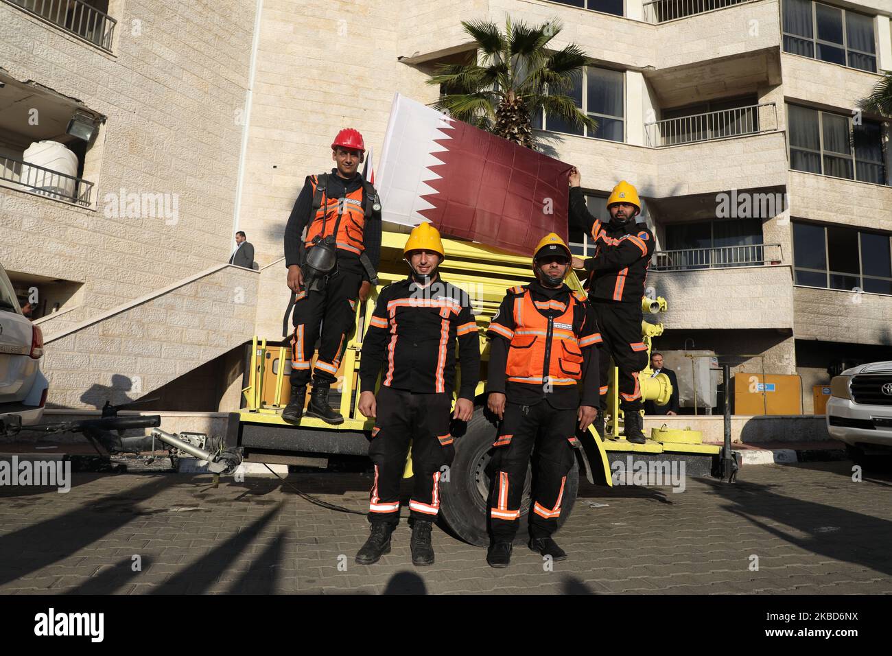 Palestinian Civil Defense Forces stand next to 24 vehicles, donated by ...