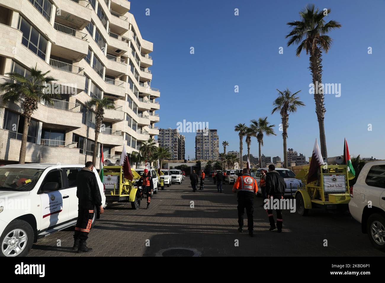 Palestinian Civil Defense Forces stand next to 24 vehicles, donated by ...