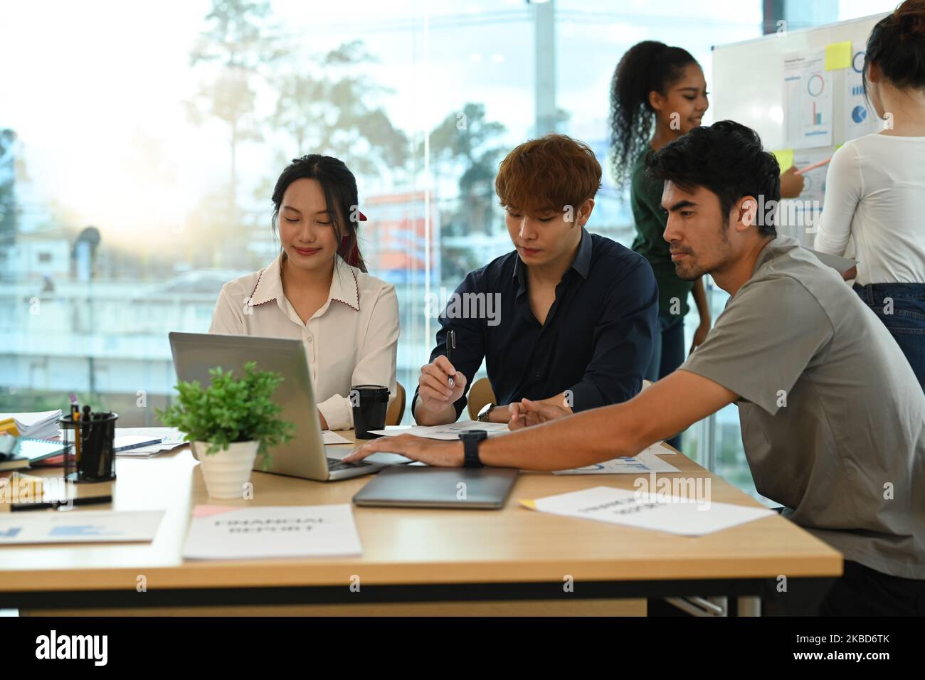 Group of start up business people brainstorming, collaborating on project development in ...