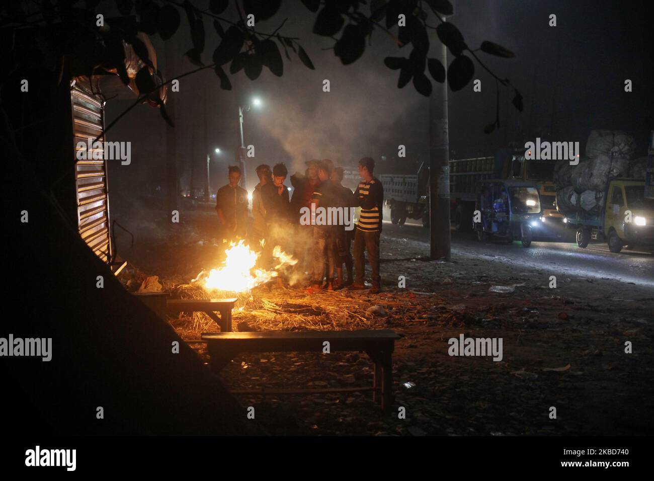 People make fire to keep them warm in a cold wave in Dhaka , Bangladesh ...