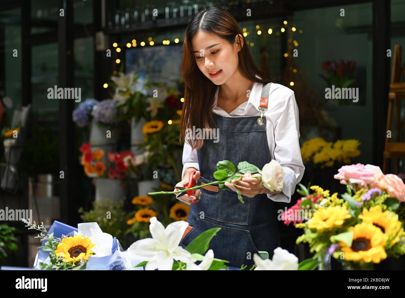 Photo of female florist creating beautiful bouquet of colorful ...