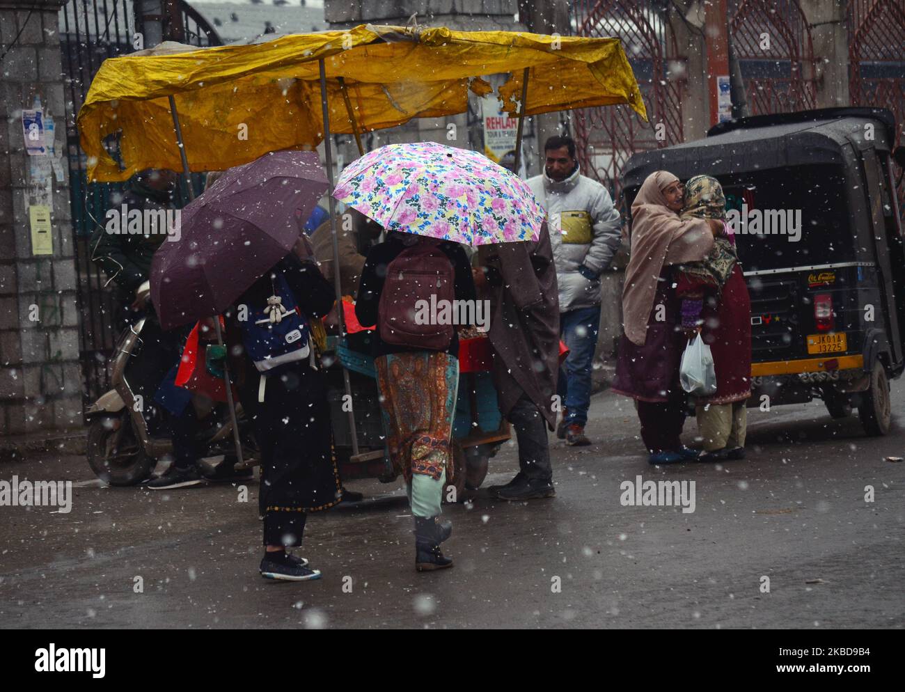 Kashmiri girls walk as snow falls in Srinagar, Kashmir on December 20 ...