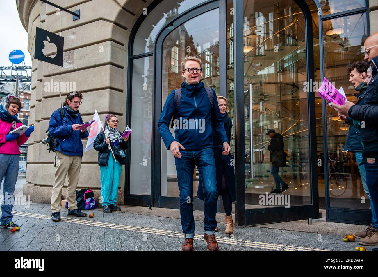 A client is going outside of the Apple store while a group of XR ...
