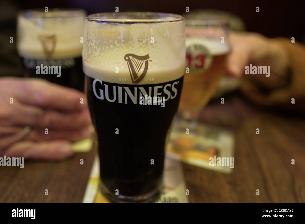 People enjoy a pint of Guinness in The Bankers Bar, in Dublin. On ...