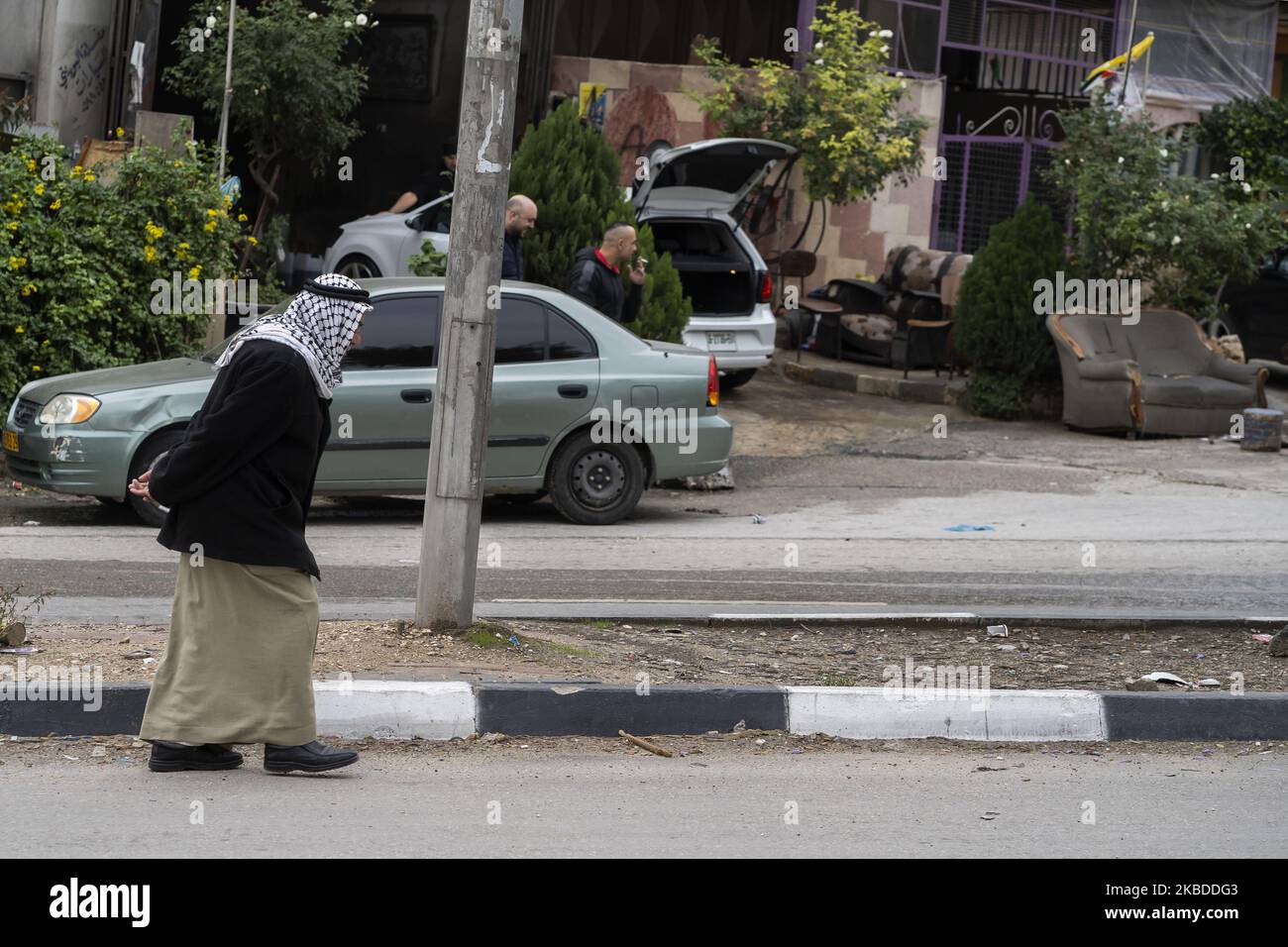 A man walks through one of the streets of Nablus, which is a city in ...
