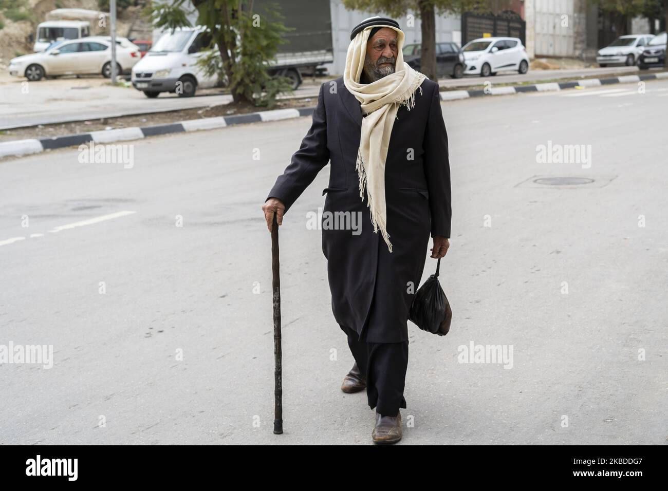 A Palestinian walks through one of the streets of Nablus, which is a ...