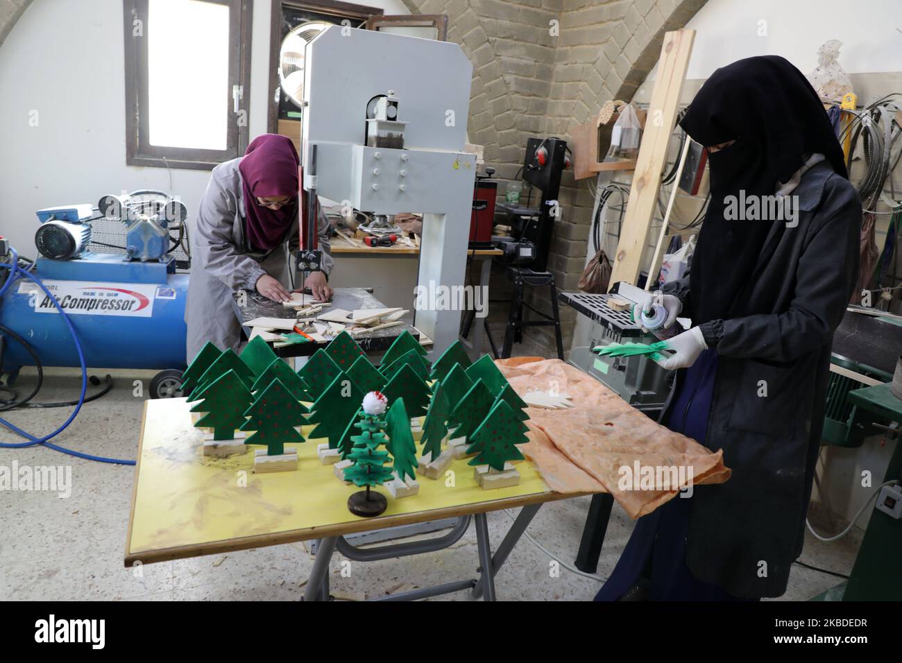 Palestinian artisans work on Christmas ornaments in the workshop of ...