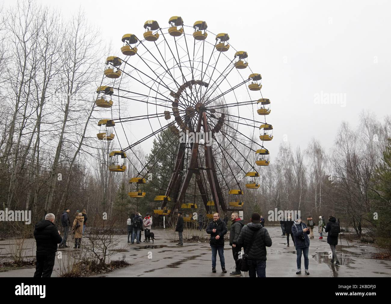 Visitors look on an abandoned city of Pripyat in Chernobyl, Ukraine, on ...