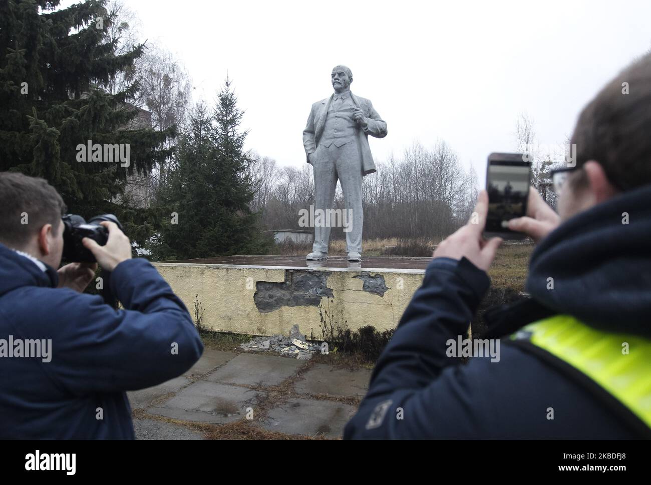 Visitors take a photo of a monument of the Soviet leader Vladimir Lenin ...