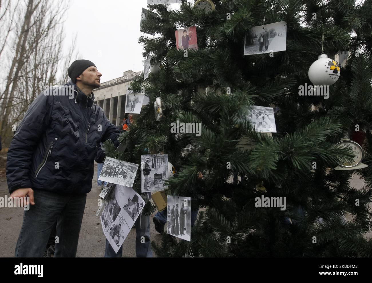 Former Pripyat's residents decorate a Christmas tree installed on a ...
