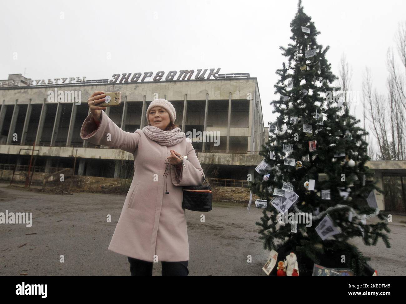 A former Pripyat's resident poses in front a Christmas tree installed ...