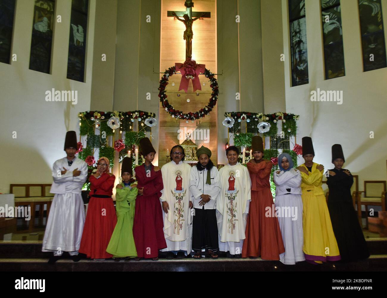 two priests (white robes) and the Muslim Sufi community posing after a ...