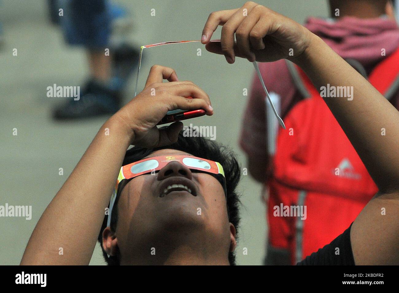 Visitors observe the phenomenon of a partial solar eclipse (GMP ...