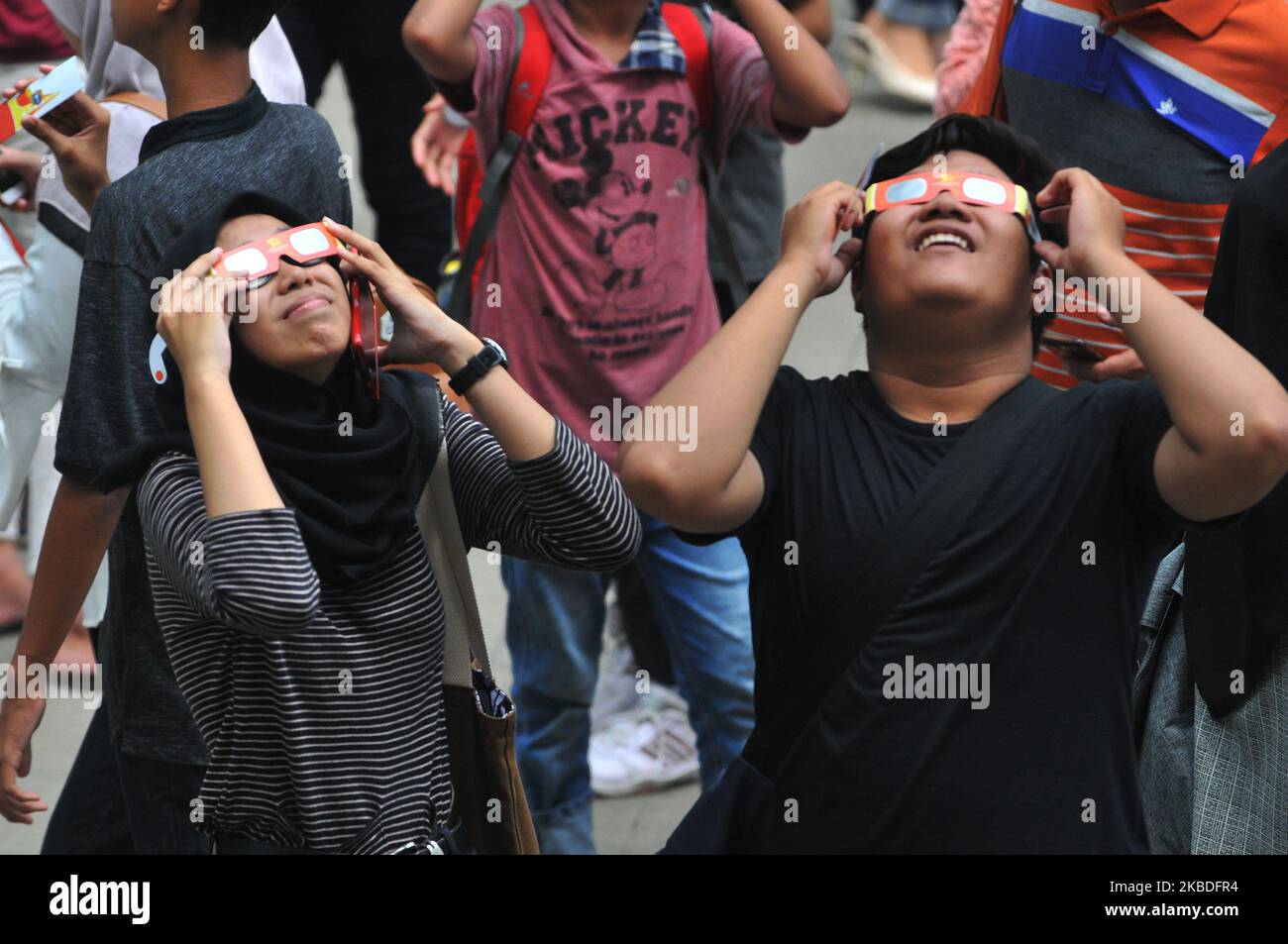 Visitors observe the phenomenon of a partial solar eclipse (GMP ...