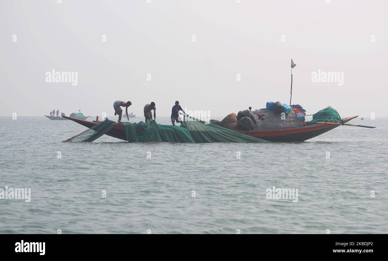 Indian Fishermen catch fishes in foggy morning on the Matla river in ...