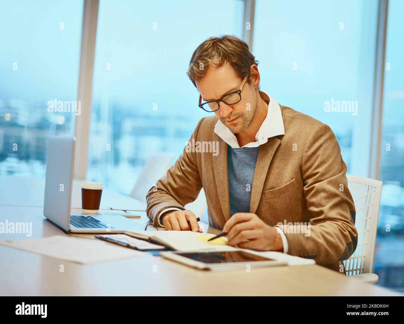 If its important, write it down. a handsome male designer working at ...