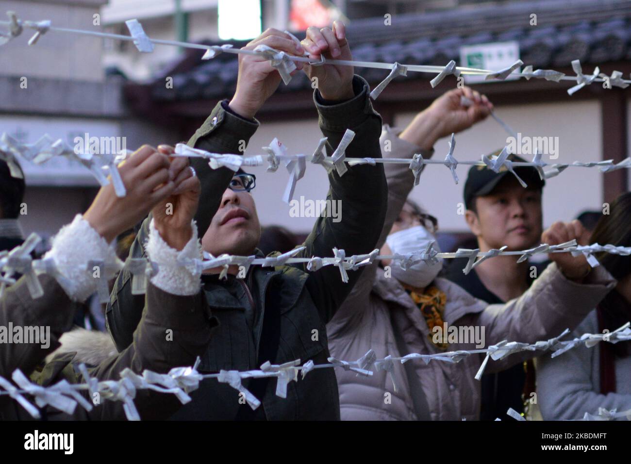 Visitors tie omikuji fortune hi-res stock photography and images - Alamy